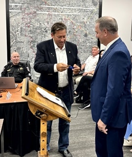 Pres-Cecola-presents-Chief-Murphy-with-badge - Village of Barrington Hills